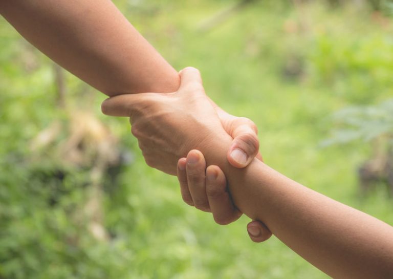 Two pairs of hand touch together, helping hands concept. Helping ...